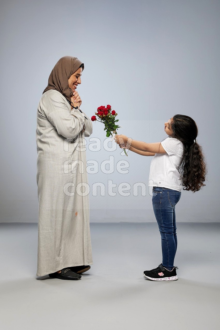 A girl giving flowers to her mother