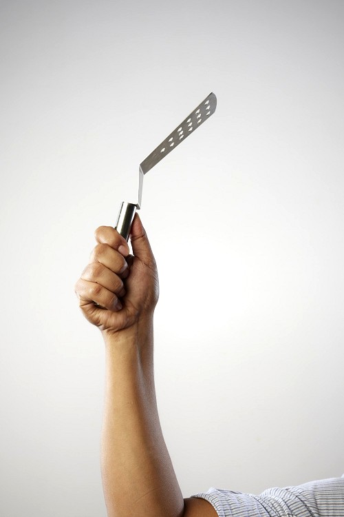 Male Hand Holding Burger Flipper