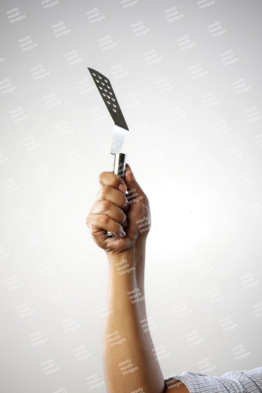Male Hand Holding Burger Flipper